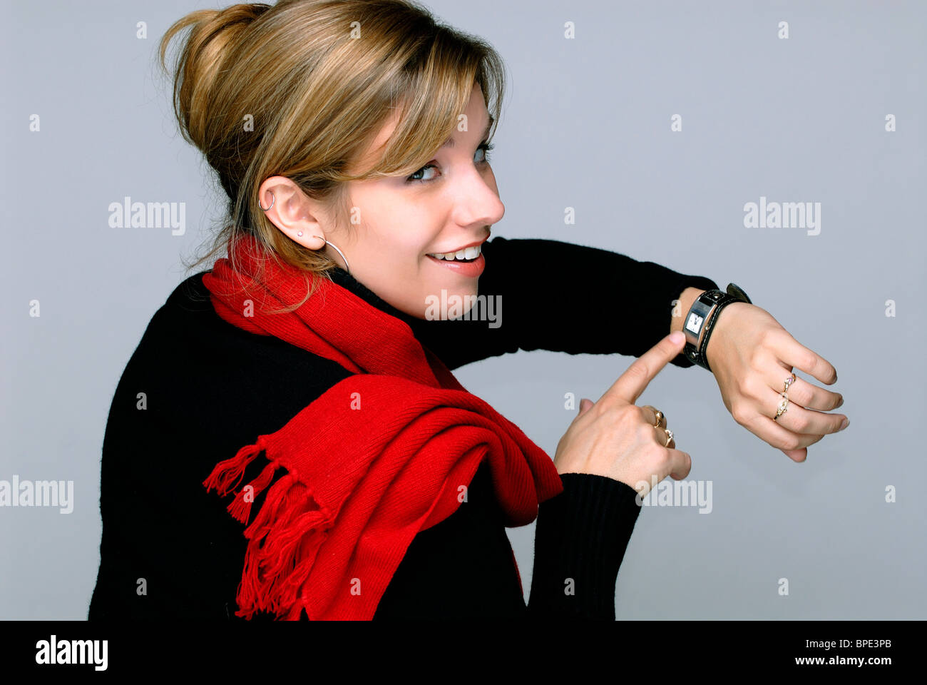Pretty Young Woman Checking The Time On Her Watch Stock Photo - Alamy