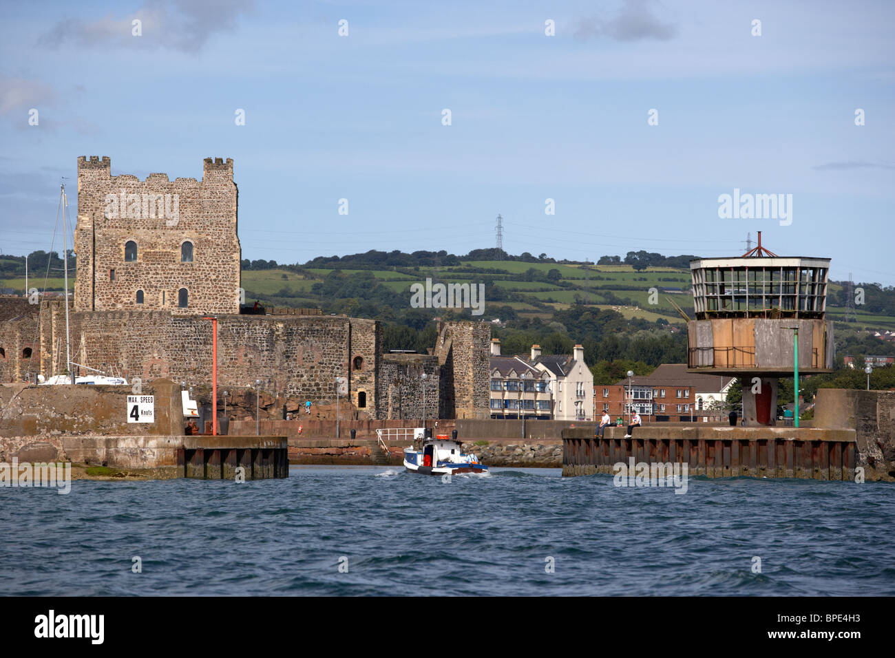 boat entering carrick harbour approaching carrickfergus castle county ...