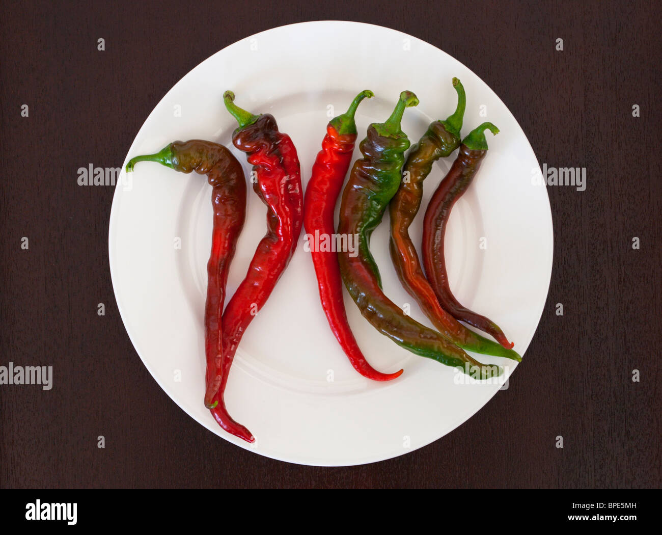 red portugal hot chile peppers white plate Stock Photo - Alamy
