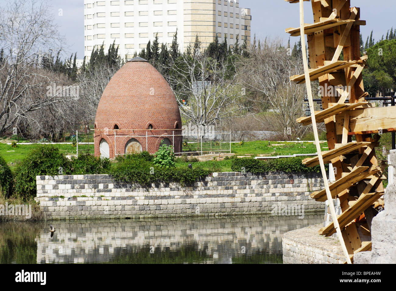 Beehive house on the bank of Orontes river in Hama, Syria. On the right ...