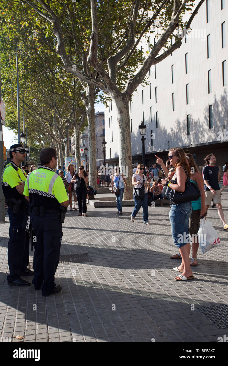 Barcelona Policemen helping people in the street, Spain Stock Photo - Alamy
