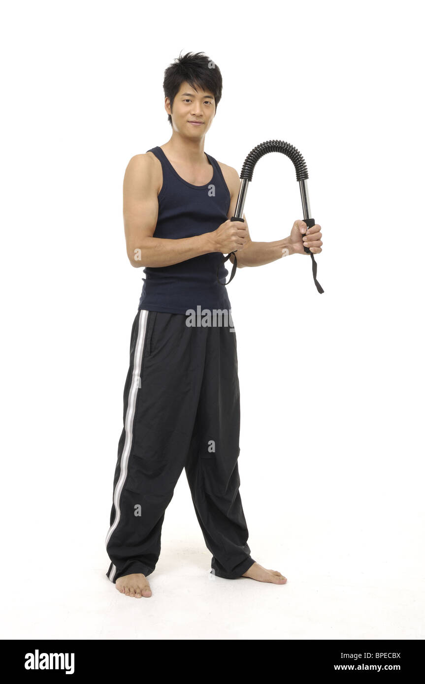 A young man exercising with expander Stock Photo - Alamy