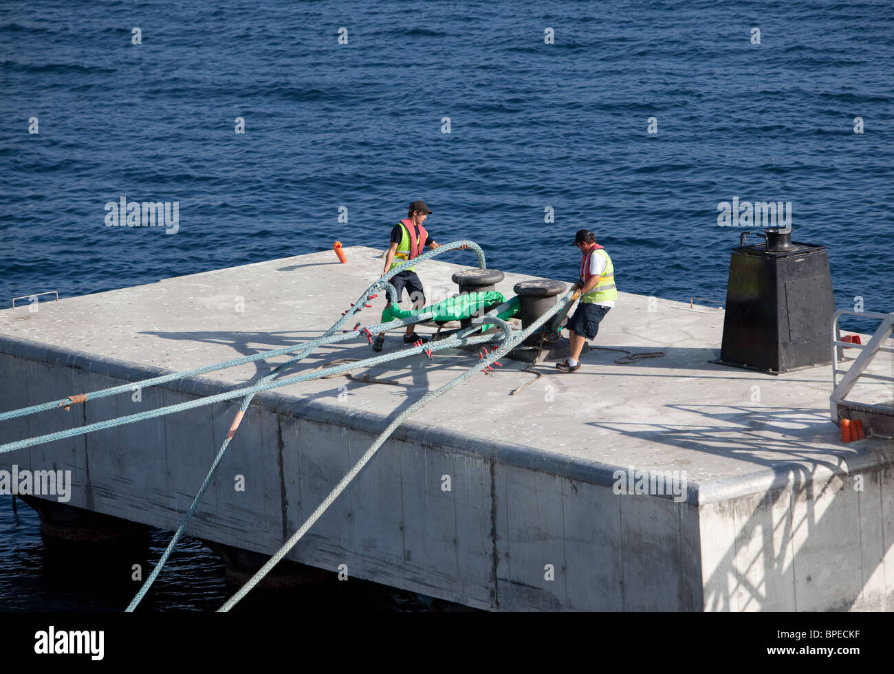 Harbour workers casting off the mooring lines of the passenger ship ...