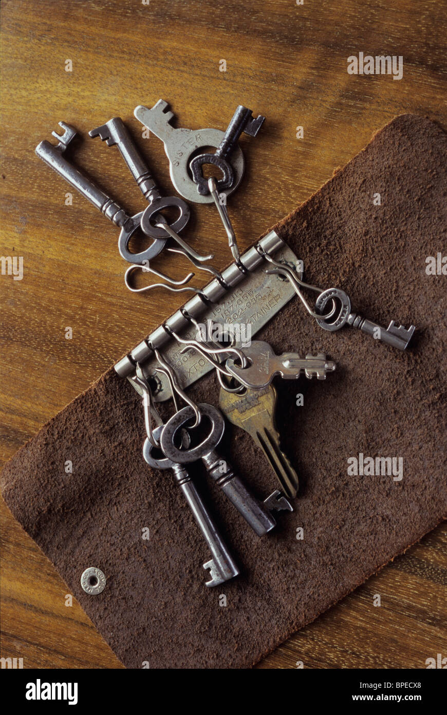 Old keys in leather key wallet on wooden table top Stock Photo - Alamy