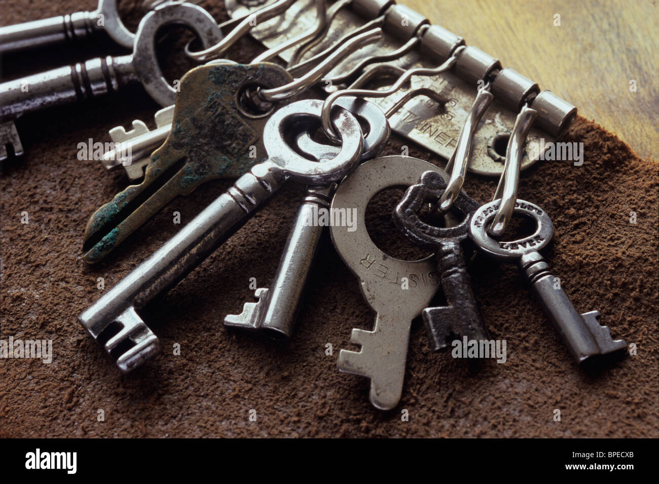Old keys in leather key wallet on wooden table Stock Photo - Alamy
