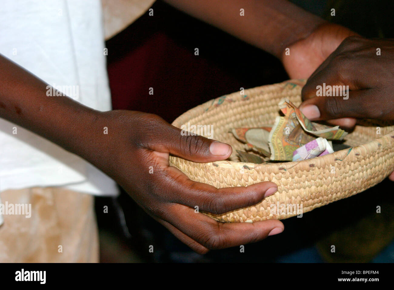 Money is placed in a collection basket during Sunday Mass in Catholic ...