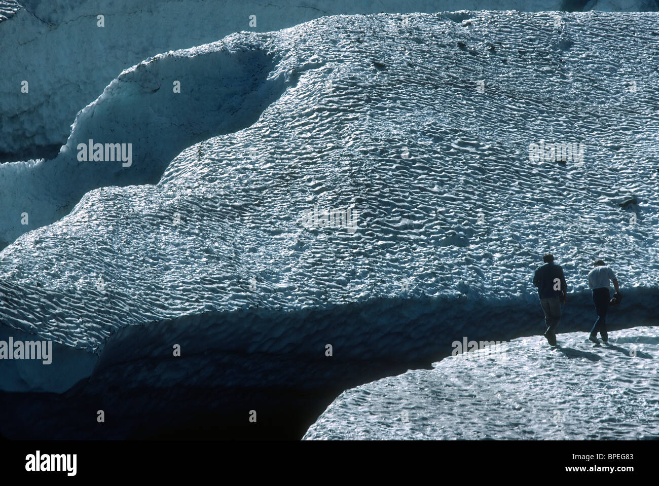 Alaska landscape with huge icebergs dominte human figures Stock Photo ...
