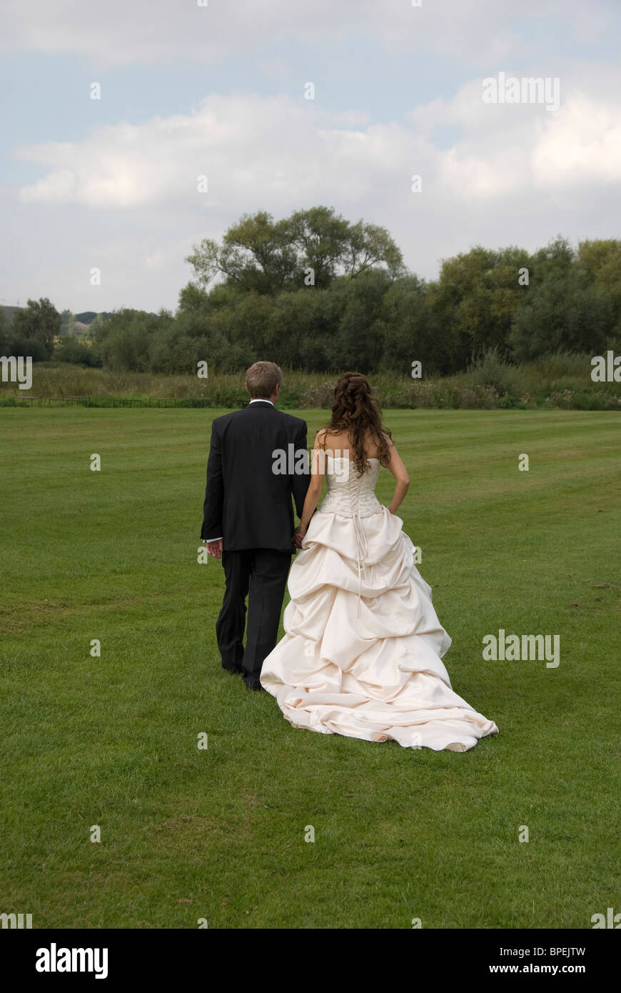Bride and groom walking away hi-res stock photography and images - Alamy