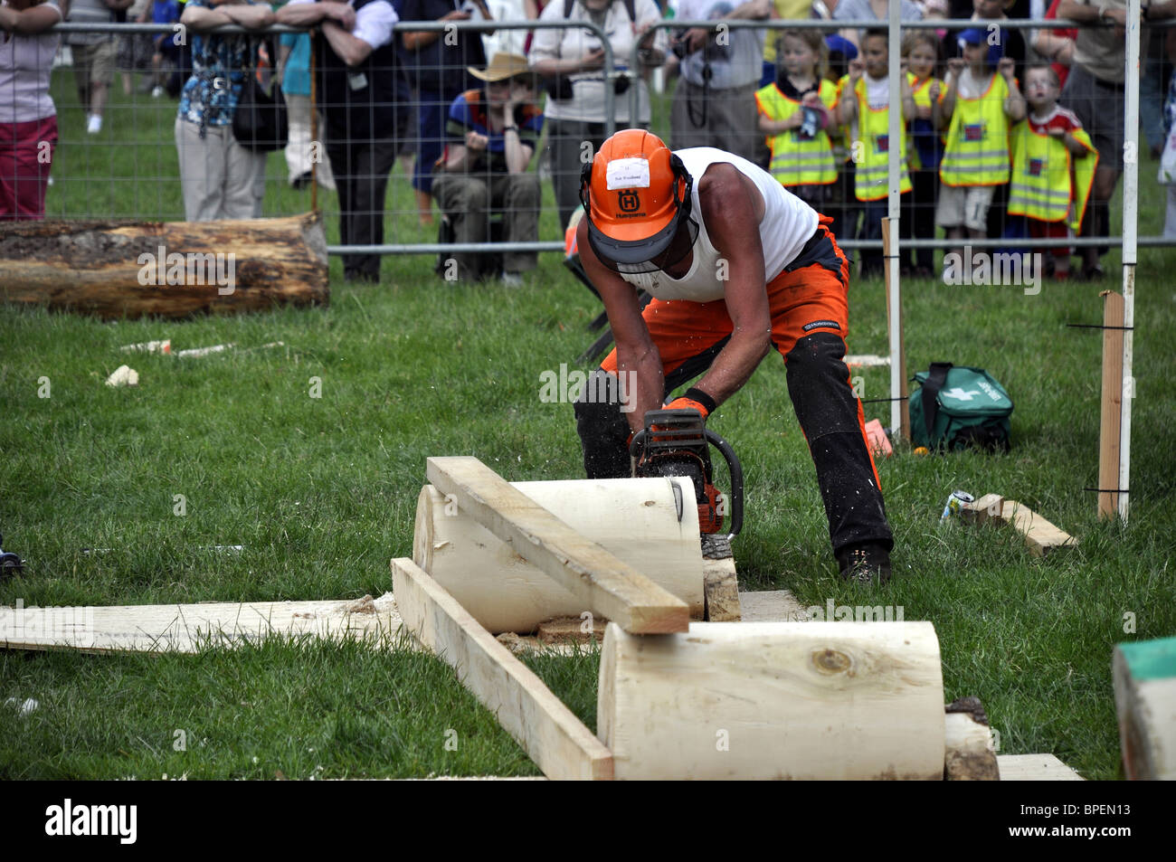 Competitor using a chainsaw in a log speed sawing competition St Asaph ...
