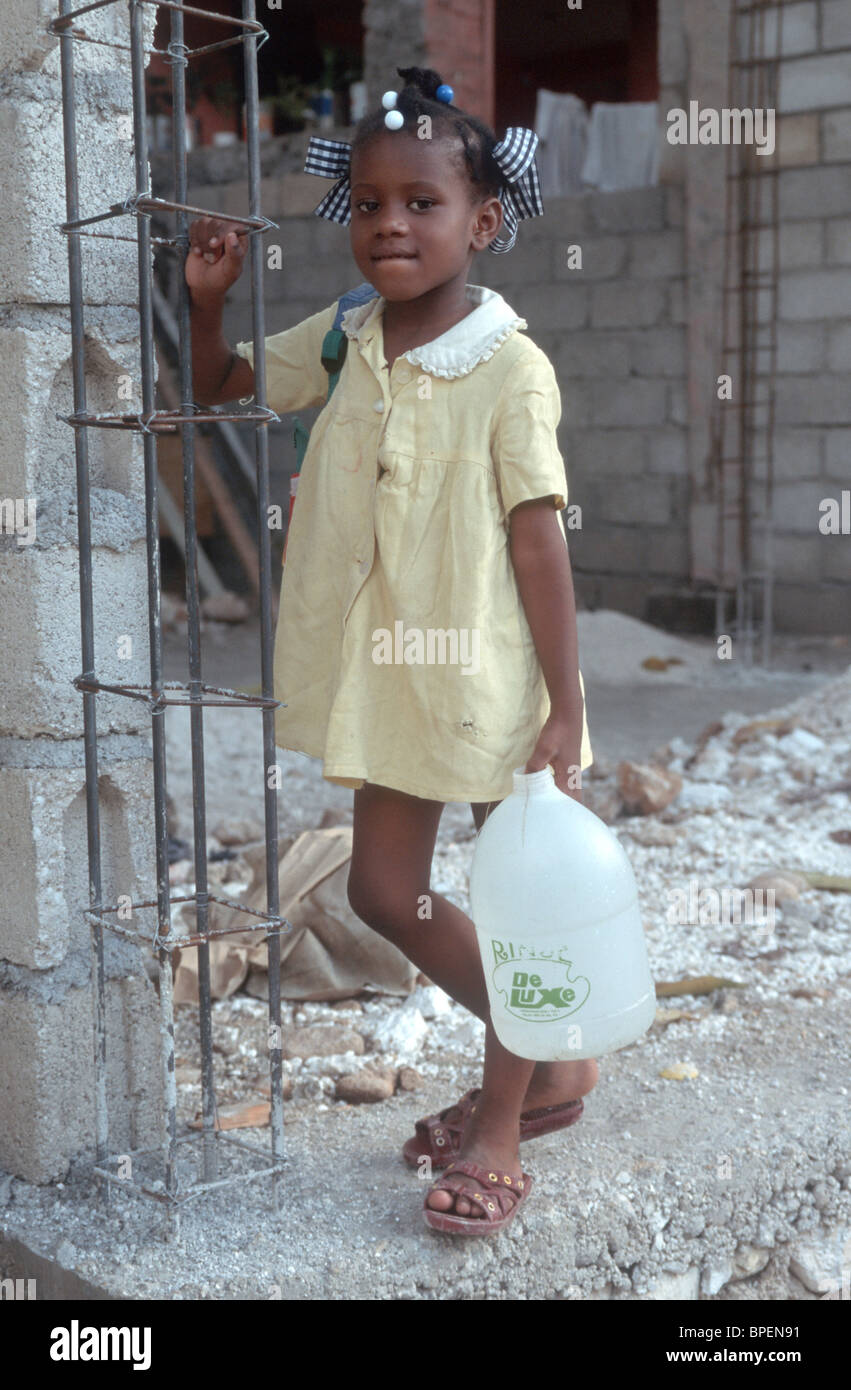 HAITI GIRL FETCHING WATER IN THE SHANTY TOWNS OF PORT AU PRINCE Stock ...