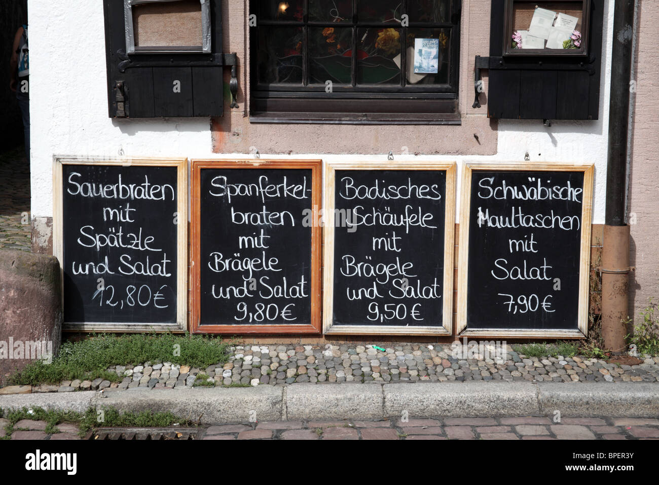 Menu boards outside a restaurant serving traditional Bavarian food ...