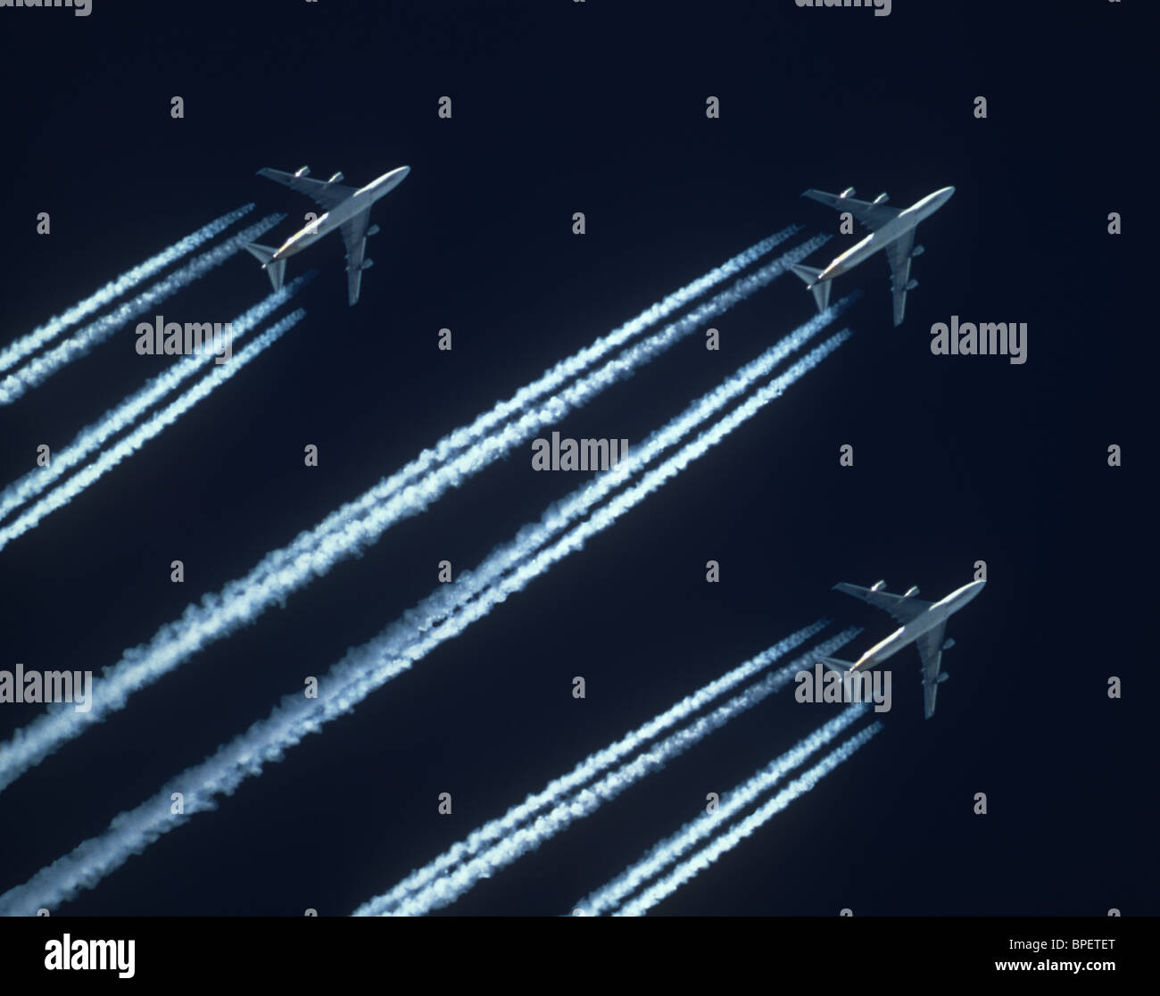 Three jets crossing the sky with vapour trails Stock Photo - Alamy