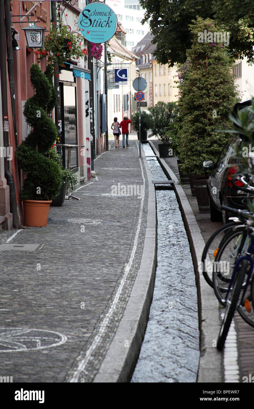 A gutter known as a Bächle in German running with fresh water. These ...