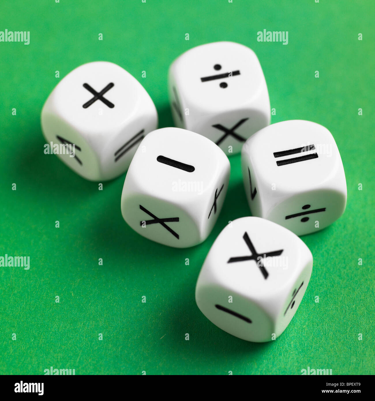 Dice With Arithmetic Symbols on Green Background Stock Photo - Alamy