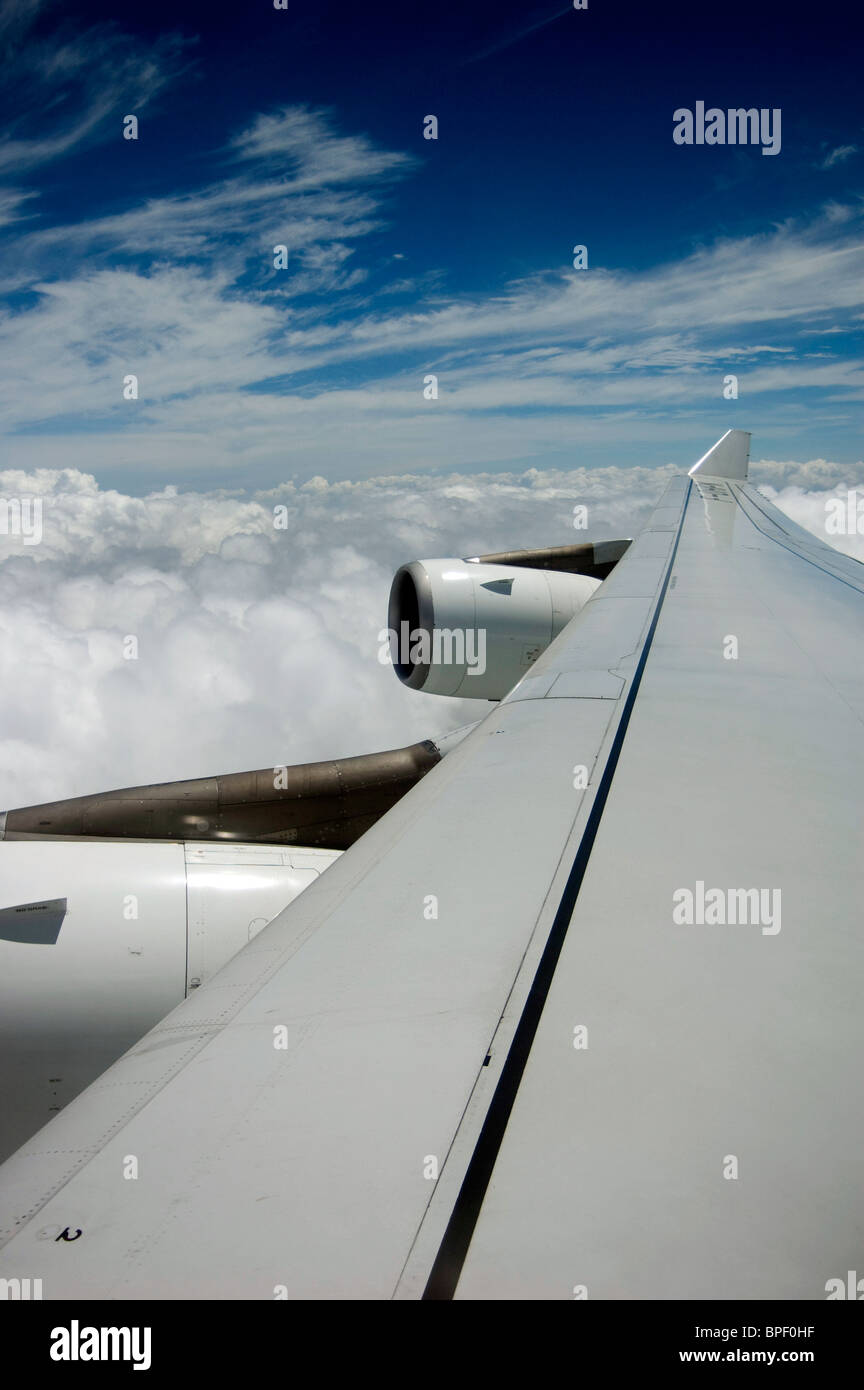 Aircraft flies through cloud formations as storm clouds rise Stock ...