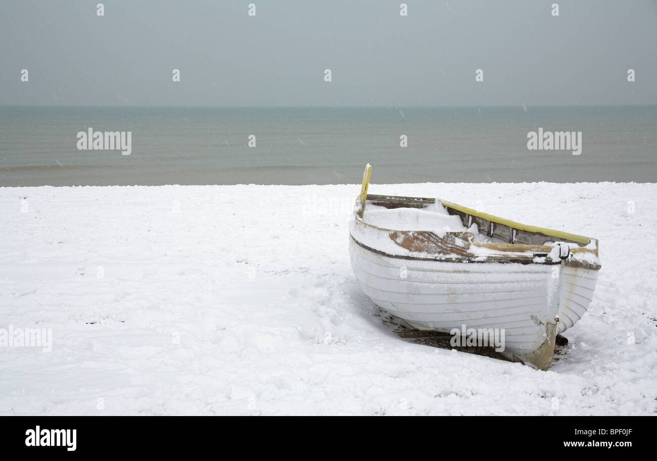 A view of a rowing boat in the snow on Brighton beach Stock Photo - Alamy
