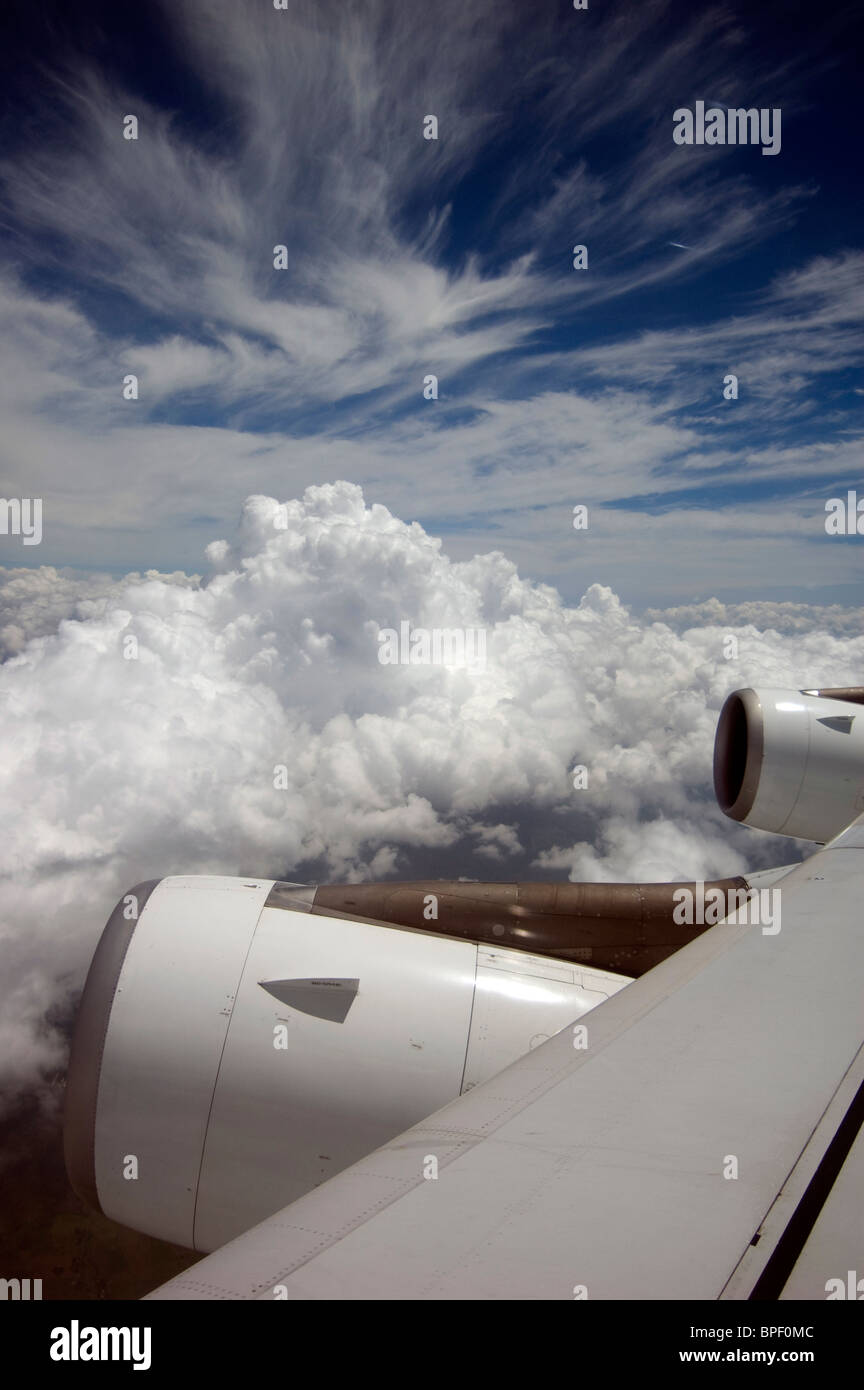 Aircraft flies through cloud formations as storm clouds rise Stock ...