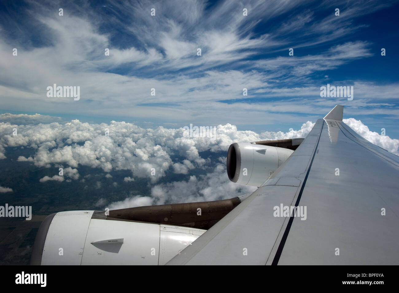 Aircraft flies through cloud formations as storm clouds rise Stock ...