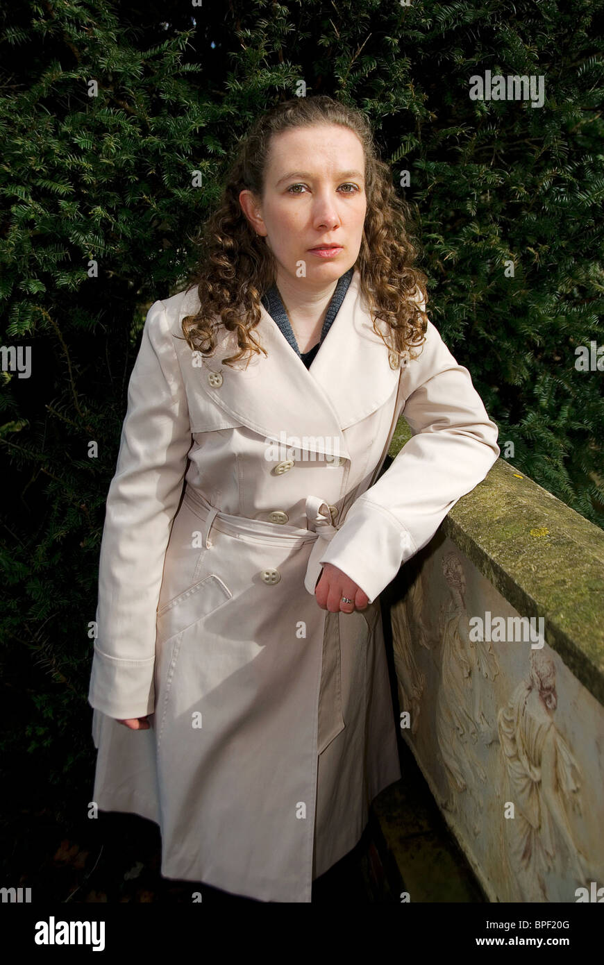 woman in beige raincoat Stock Photo - Alamy