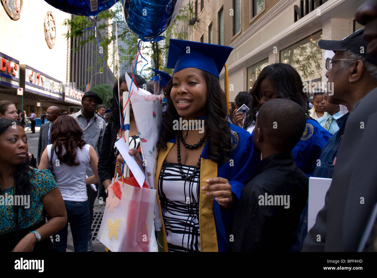Graduates from Pace University celebrating in New York City following ...
