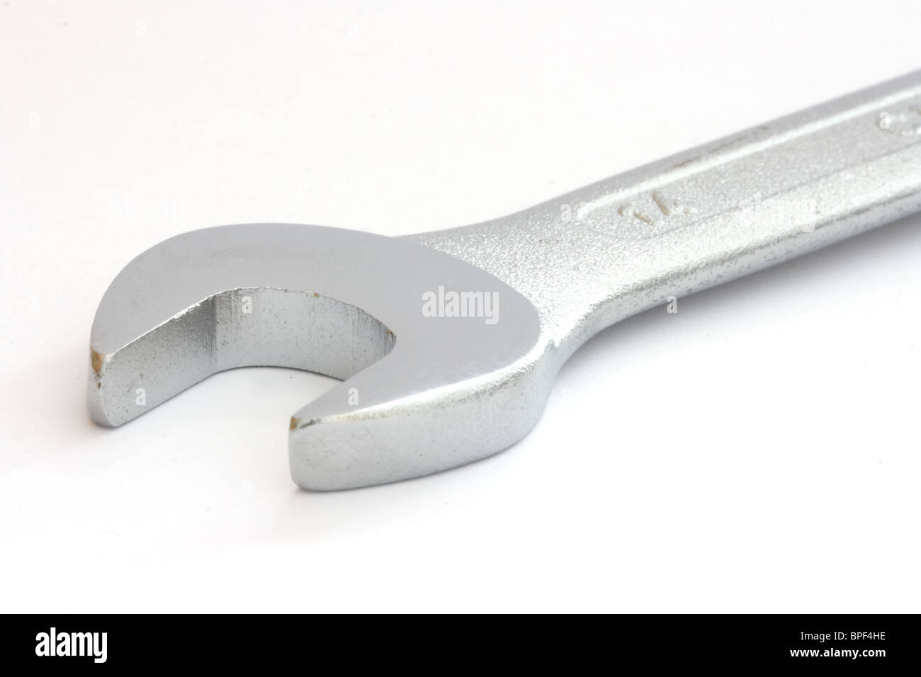 Single metal wrench part on white background Stock Photo - Alamy