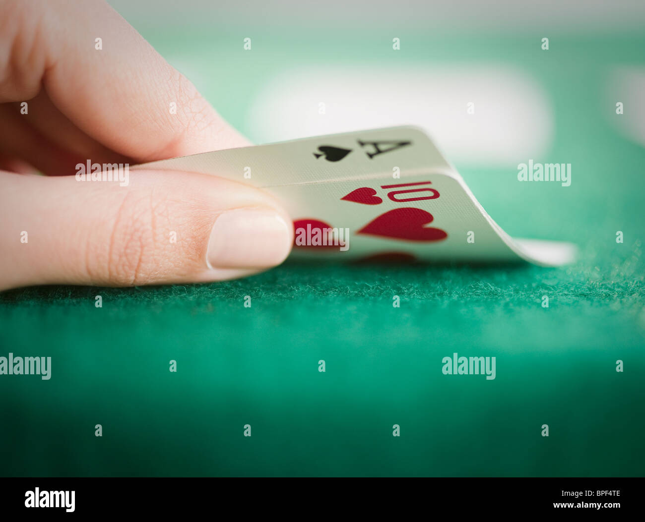 Hand gambler checking playing cards hi-res stock photography and images ...