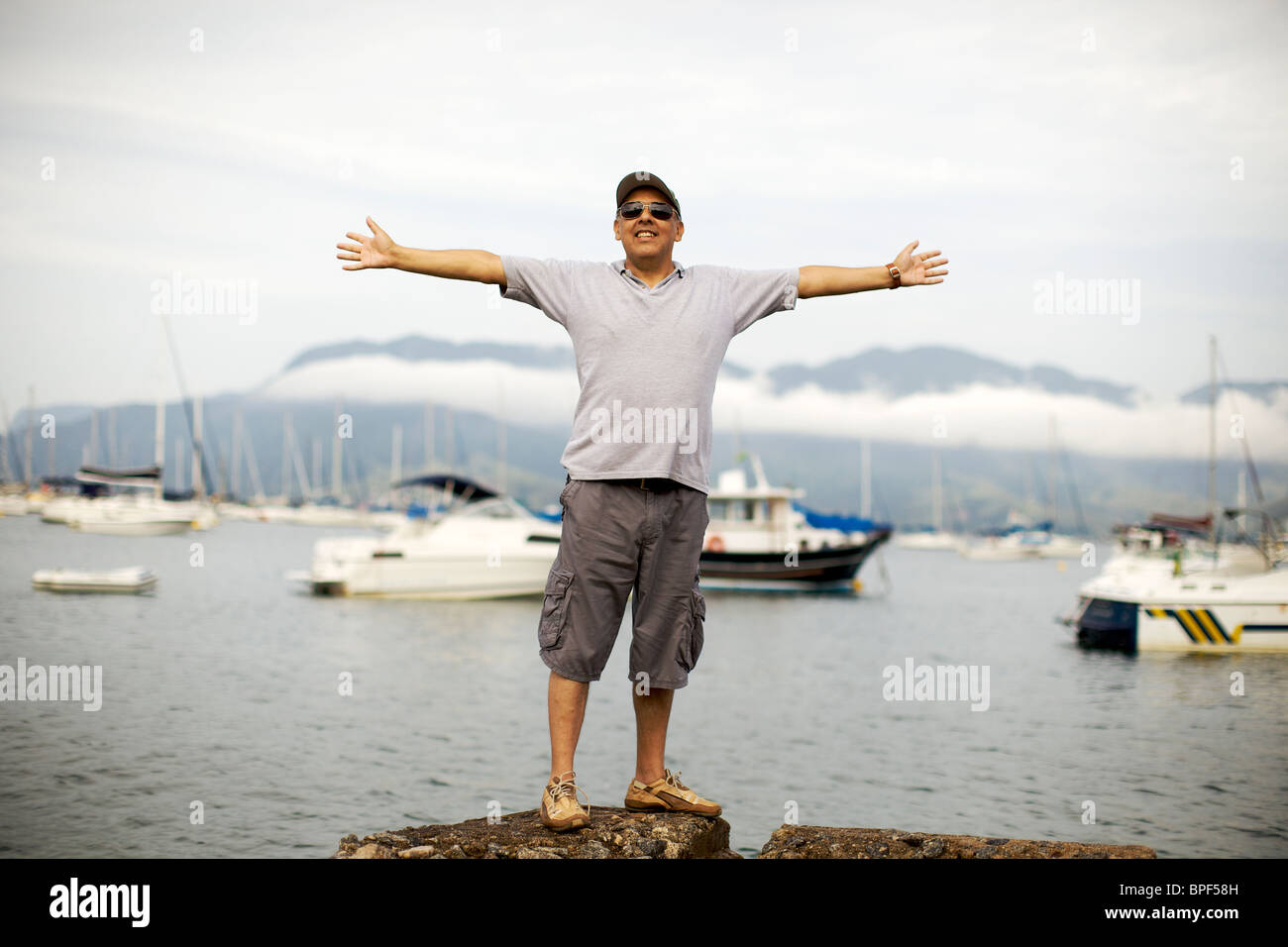 Hispanic man standing at waterfront Stock Photo - Alamy