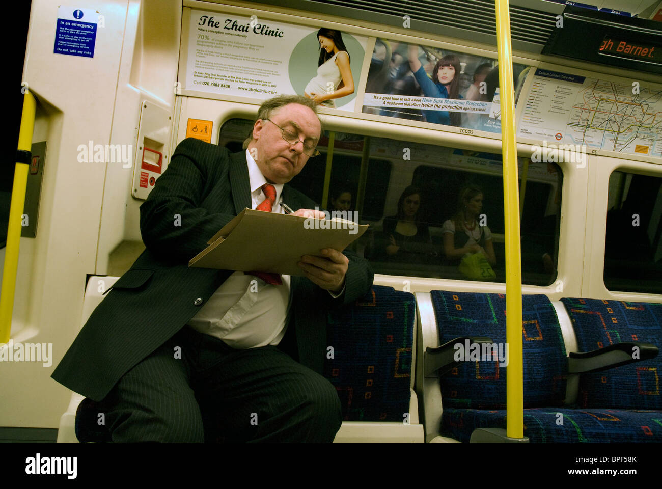 London underground man sitting hi-res stock photography and images - Alamy