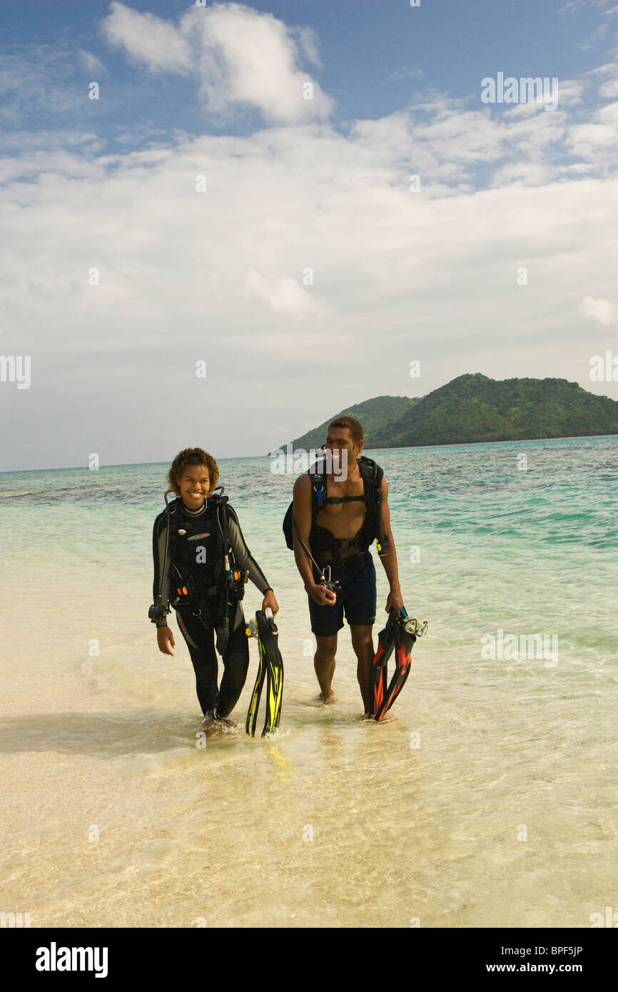 Couple enjoying a day of snorkeling and scuba diving on Picnic Island ...
