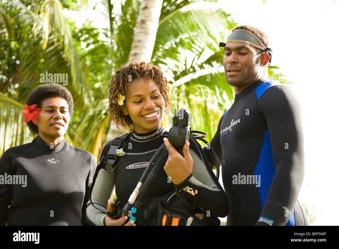 man and woman gearing up for a shore dive. Beqa Lagoon Resort, Beqa ...