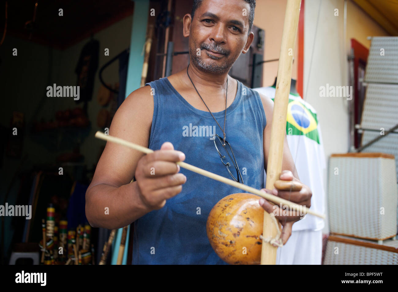 Mixed race man standing with musical instrument Stock Photo - Alamy