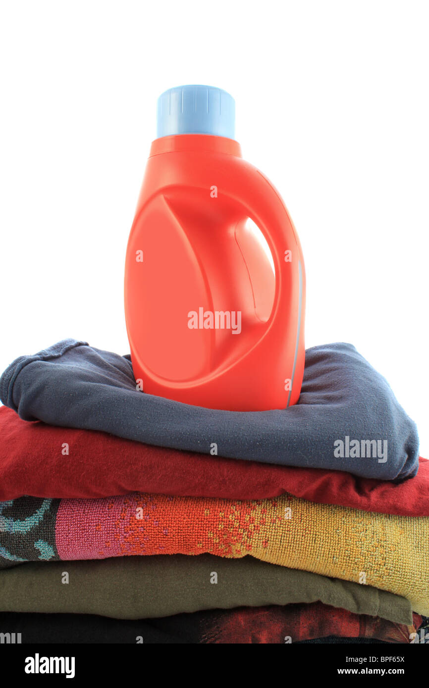 Liquid laundry detergent on top of folded pile of clothes Stock Photo ...