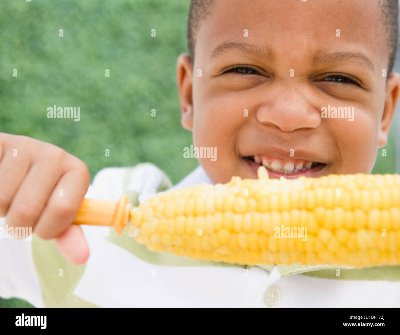 African American boy eating corn on the cob Stock Photo - Alamy