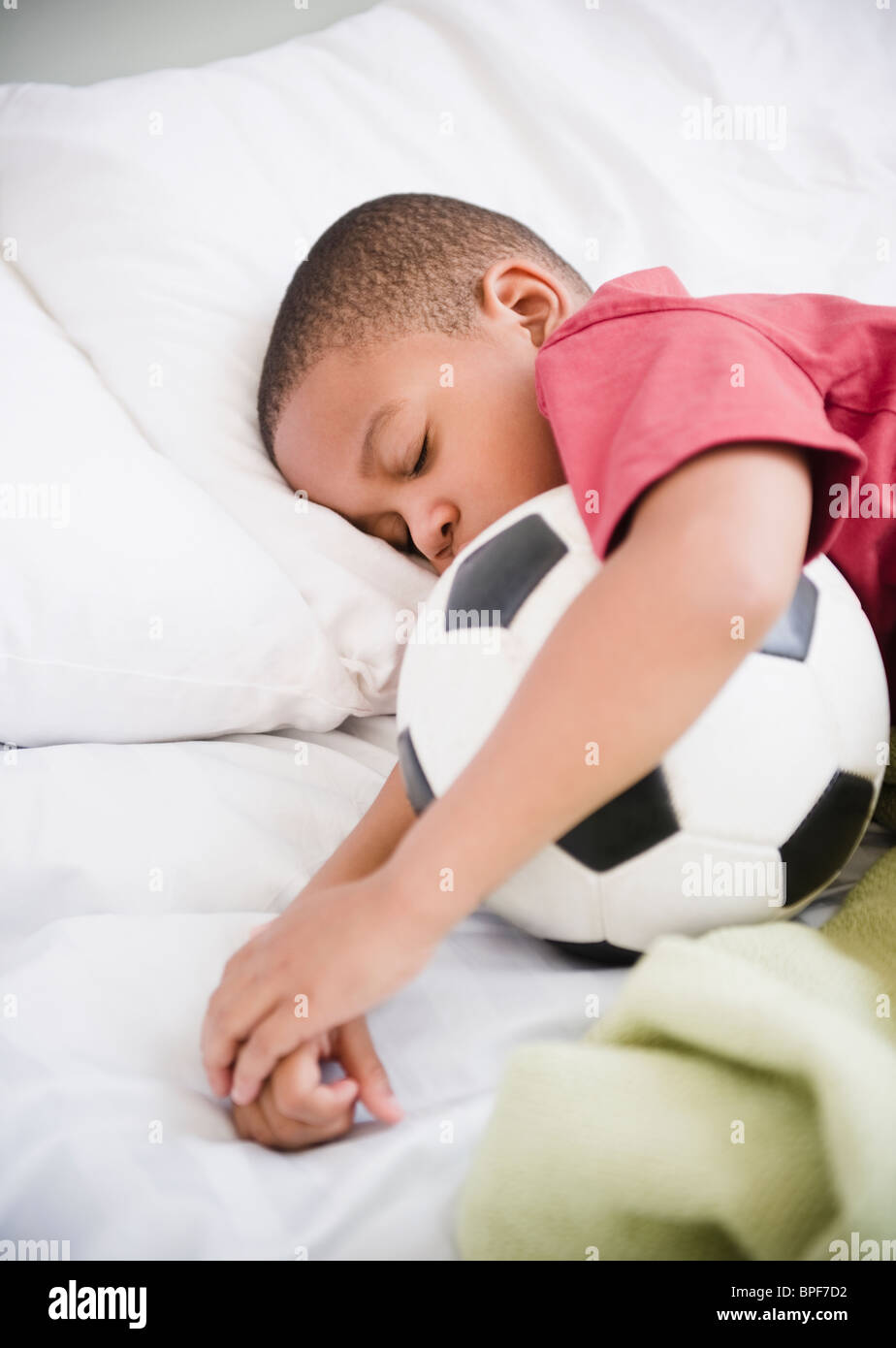 African American boy sleeping with soccer ball Stock Photo - Alamy