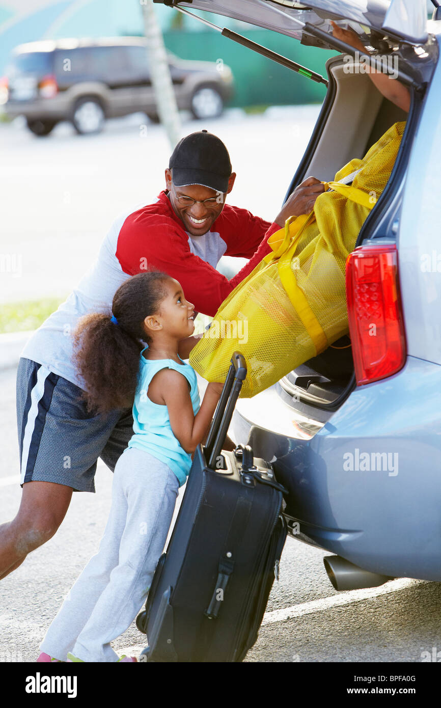 Girl loading luggage into car hi-res stock photography and images - Alamy
