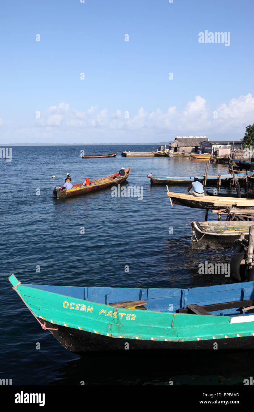 Turquoise painted "Ocean Master" and other wooden fishing boats on ...