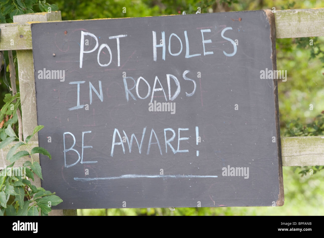 A pot hole warning sign Stock Photo - Alamy