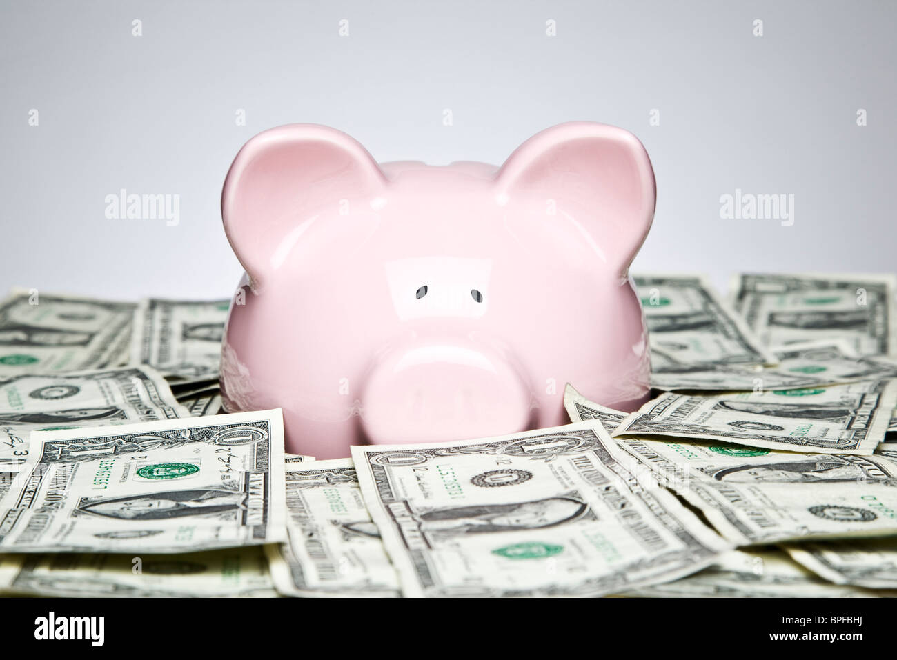 Dollar bills and piggy bank Stock Photo - Alamy