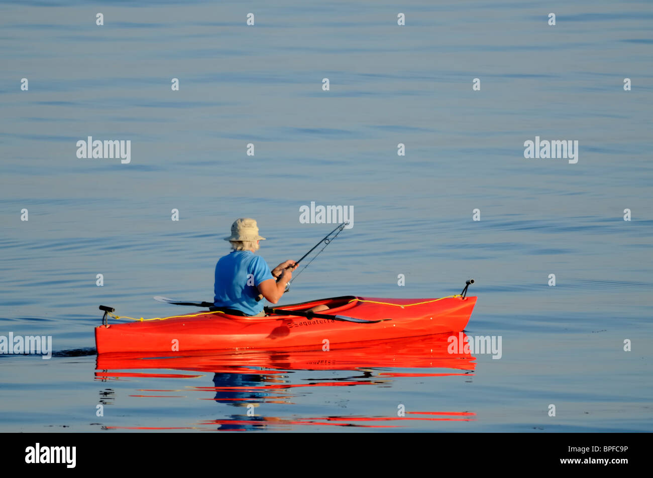 A woman fishing for salmon in the Georgia Strait, Point Holmes ...