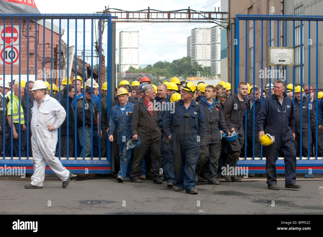 Workers at BAE Systems Govan Shipyard in Glasgow leave via the front ...