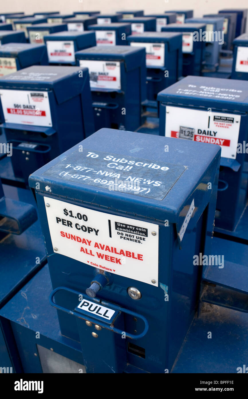 Rows of surplus newspaper boxes sit in an alley behind a building in ...
