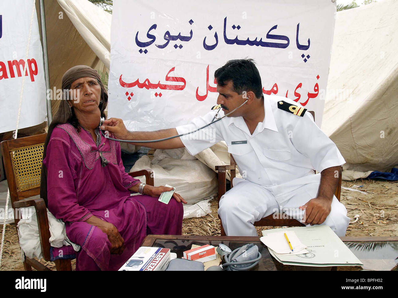 Navy (PN) doctor examines patient at medical camp established at a ...