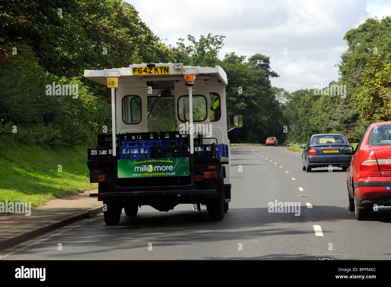 Electric driven milk float vehicle driving along a dual carriageway ...