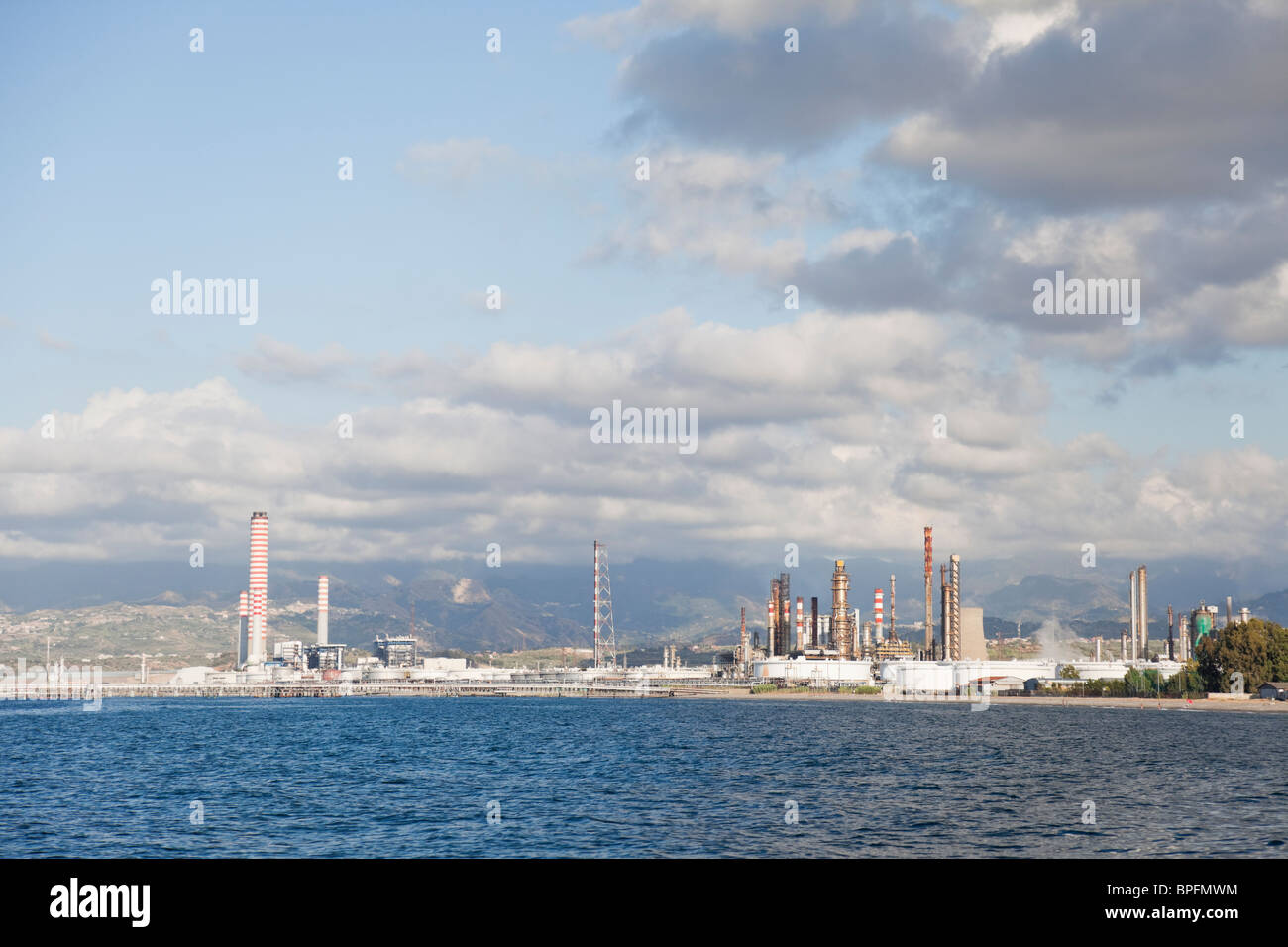 The oil refinery industrial port, with many chimneys and pipes Stock ...
