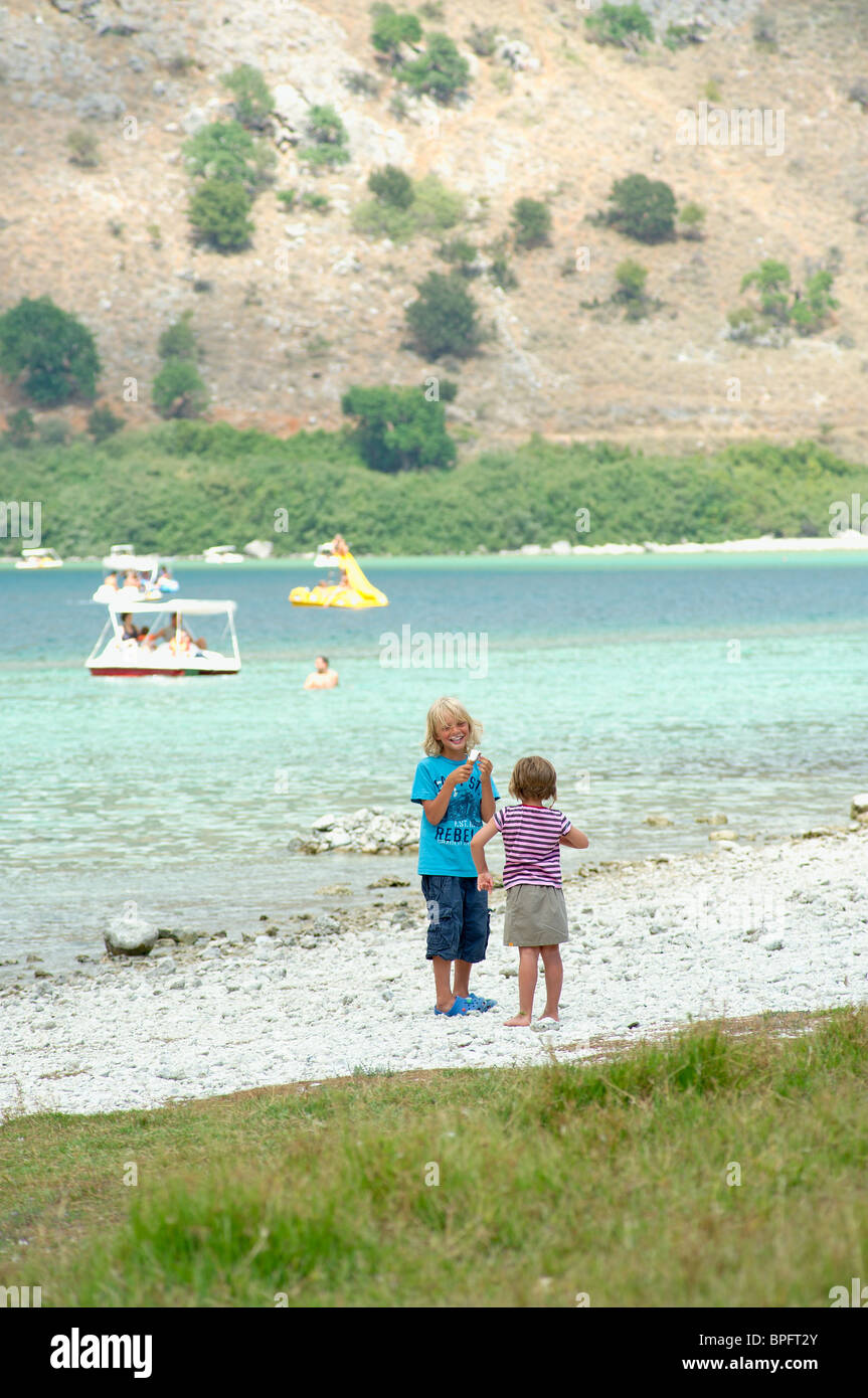 Two young children eating ice cream at Lake Kournas Chania county Crete ...