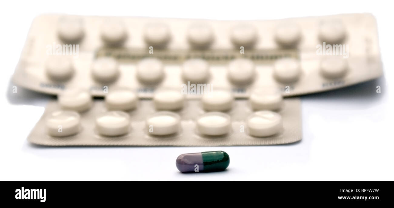Tablets and capsules of medications isolated on a white background ...