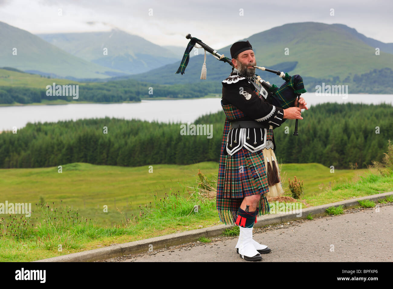 Bagpipe player on the Scottish Highlands Stock Photo - Alamy