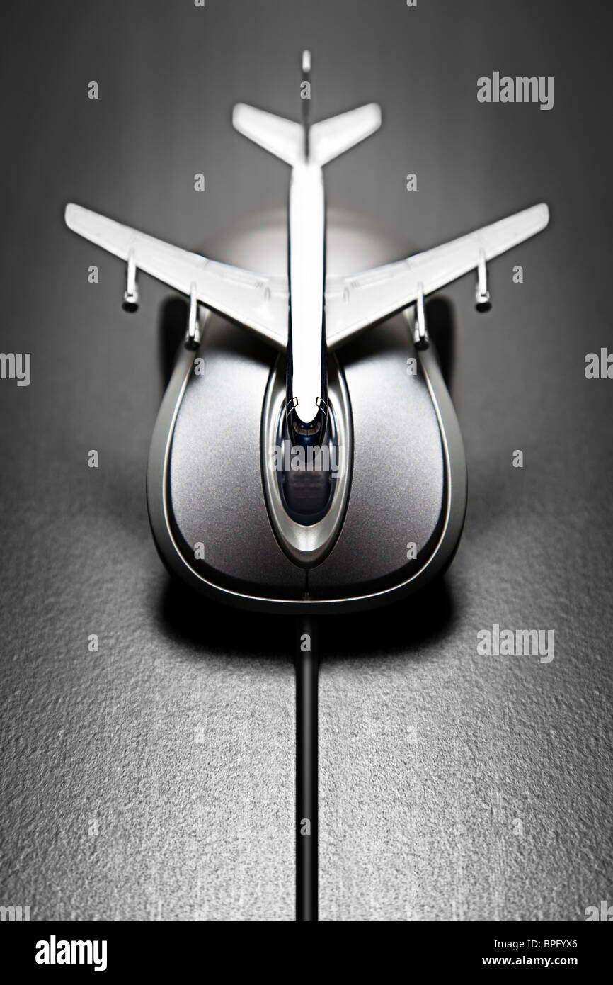 Toy airplane placed on a computer mouse Stock Photo - Alamy
