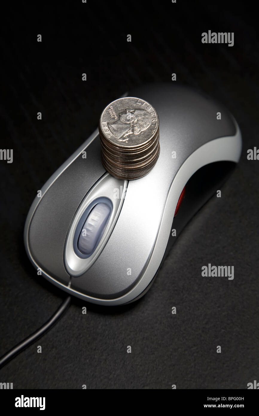 Computer mouse with a stack of coins Stock Photo - Alamy