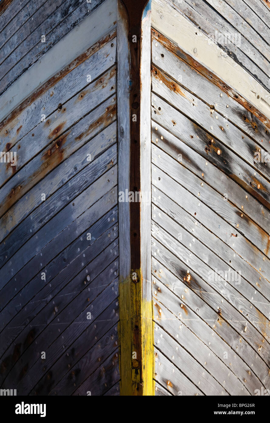 Wooden hull of an old fishing boat, shipyard, Troon, Ayrshire, Scotland ...